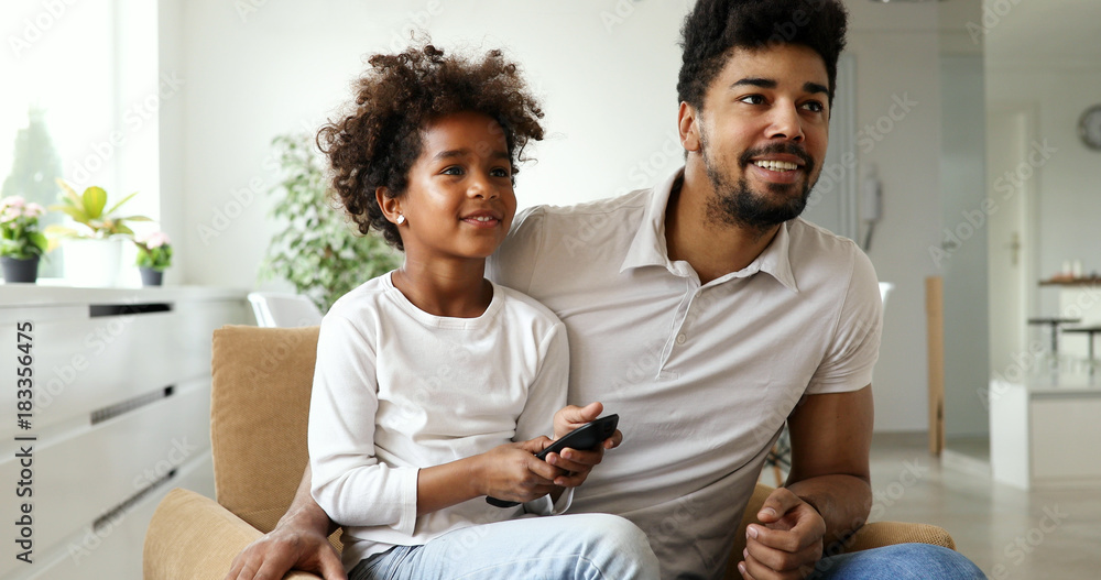 Relaxed african american family watching tv Stock Photo | Adobe Stock