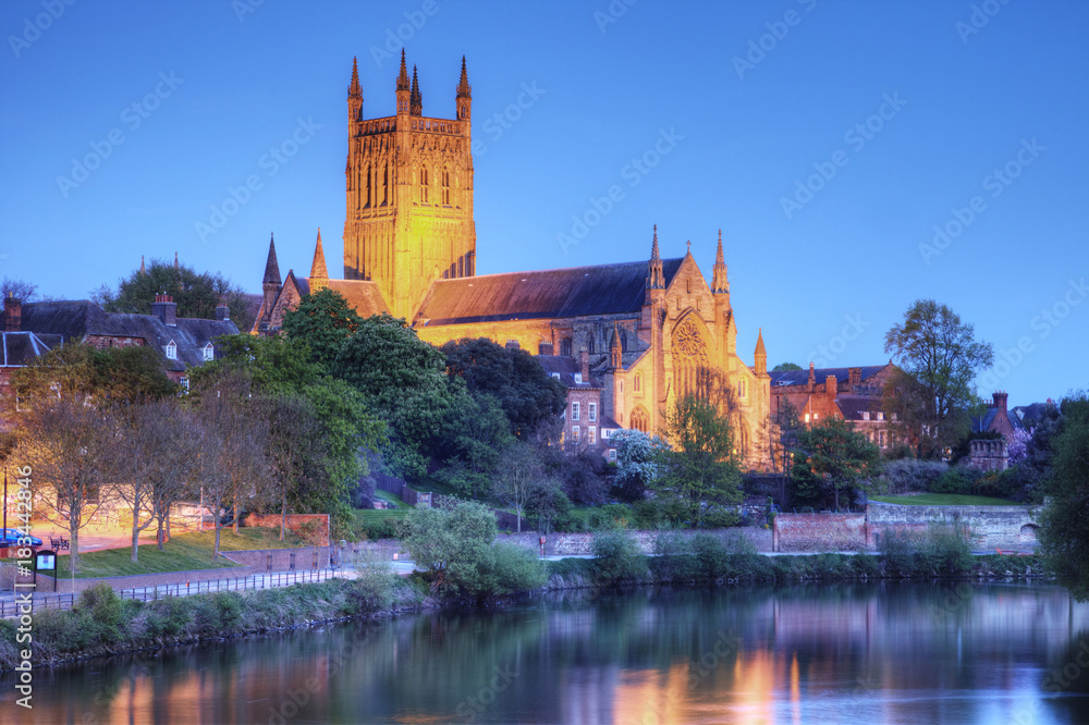 Worcester Cathedral floodlit on a spring evening and reflected in the ...