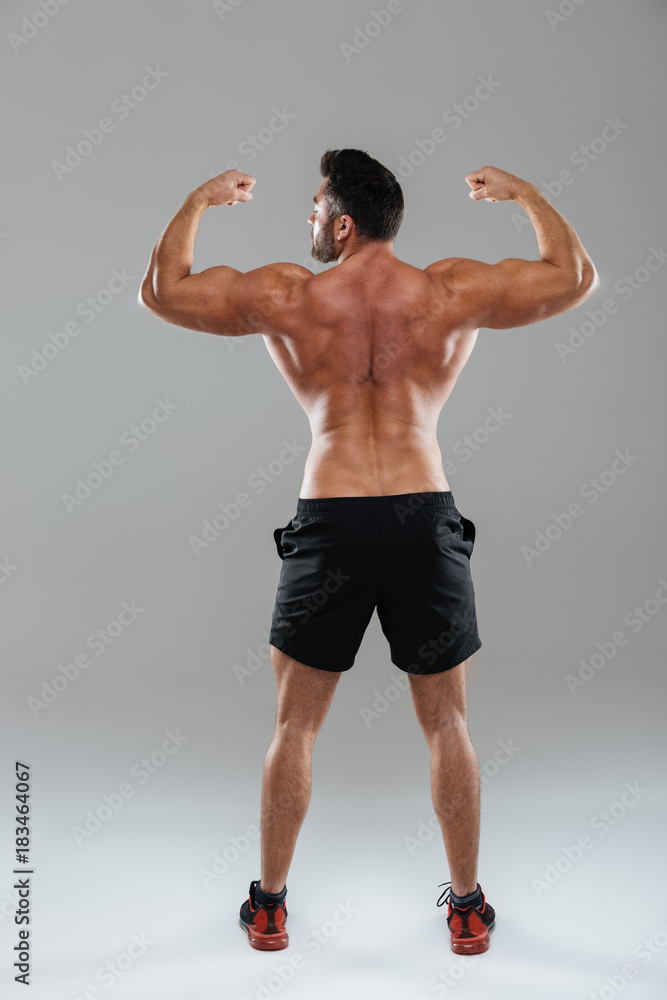 Back view full length portrait of a shirtless male bodybuilder Stock ...