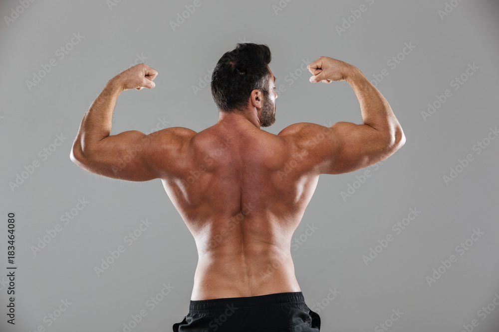 Back view portrait of a muscular male bodybuilder flexing muscles Stock ...