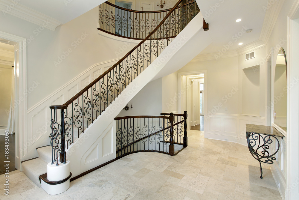 Foyer with wrought iron staircase railing Stock Photo | Adobe Stock