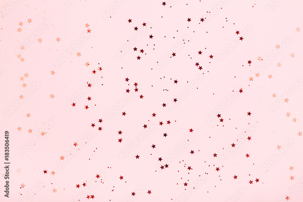 Pink background with red star glitter. Stock Photo | Adobe Stock