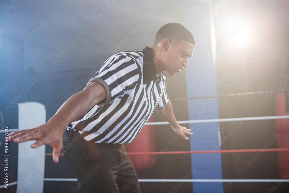 Young male referee showing hand sign in boxing ring Stock Photo | Adobe ...