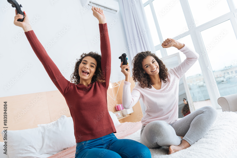 Having so much fun. Radiant young ladies in casual smiling into the ...