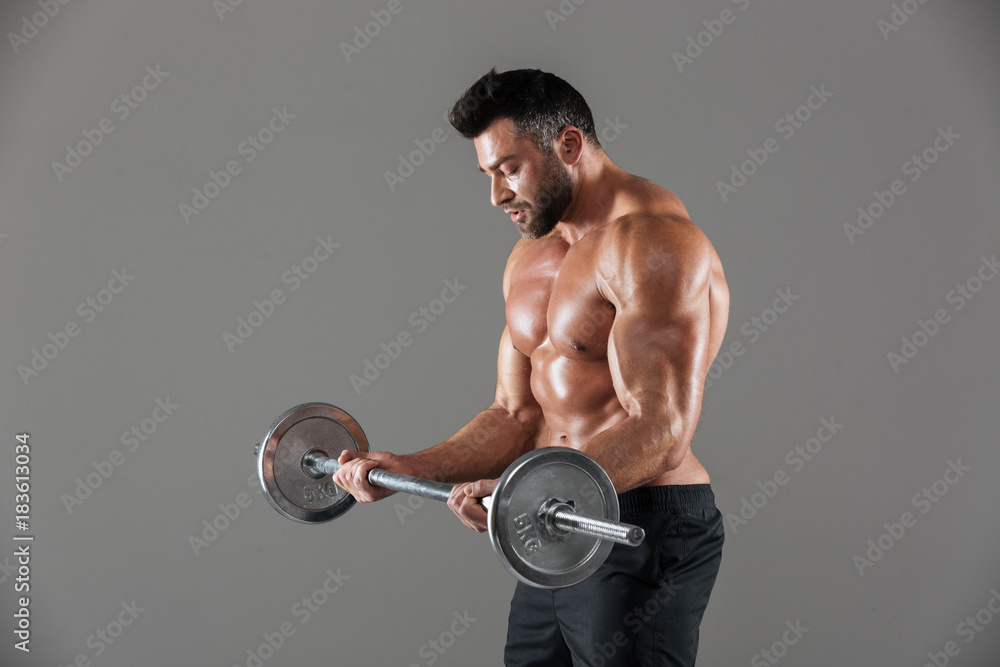 Side view of a concentrated strong shirtless male bodybuilder Stock ...