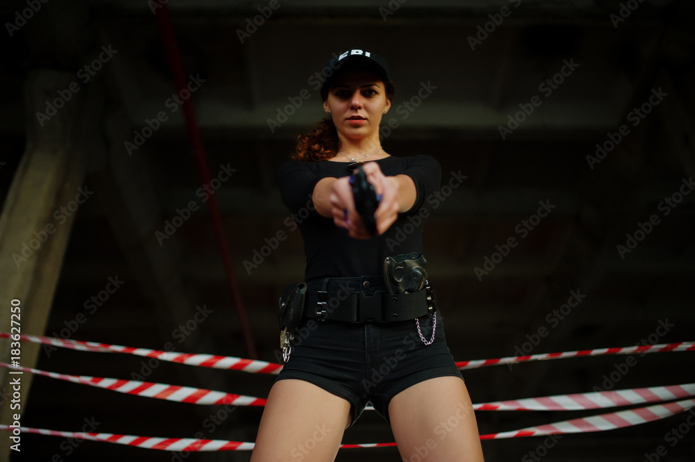 Sexy FBI female agent at abadoned place. Stock Photo | Adobe Stock