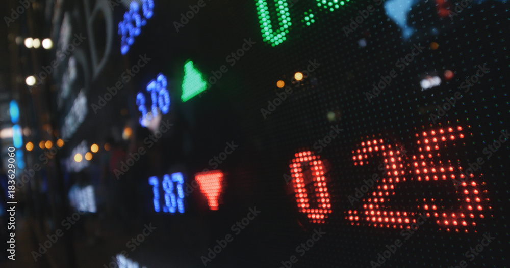 Stock market graph showing prices on window screen at night Stock Photo ...