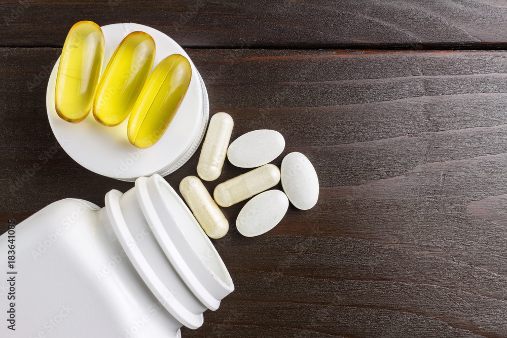 Complex of vitamins and dietary supplement, yellow capsules omega 3 ...