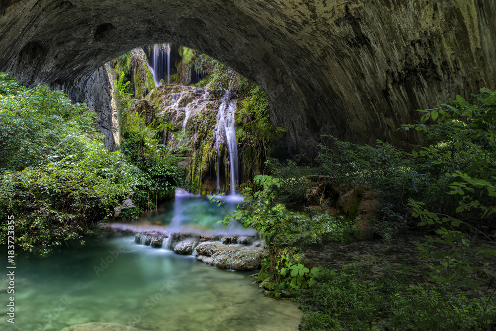 cave entrance with trees and river inside Stock Photo | Adobe Stock