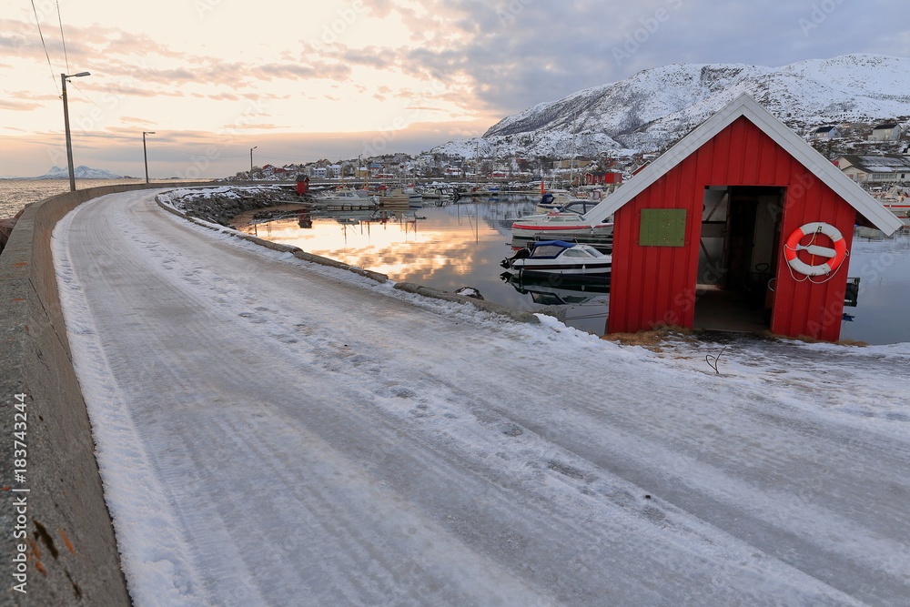 Red fishing hut in the harbor-Lodingsaksla mounts background. Lodingen ...