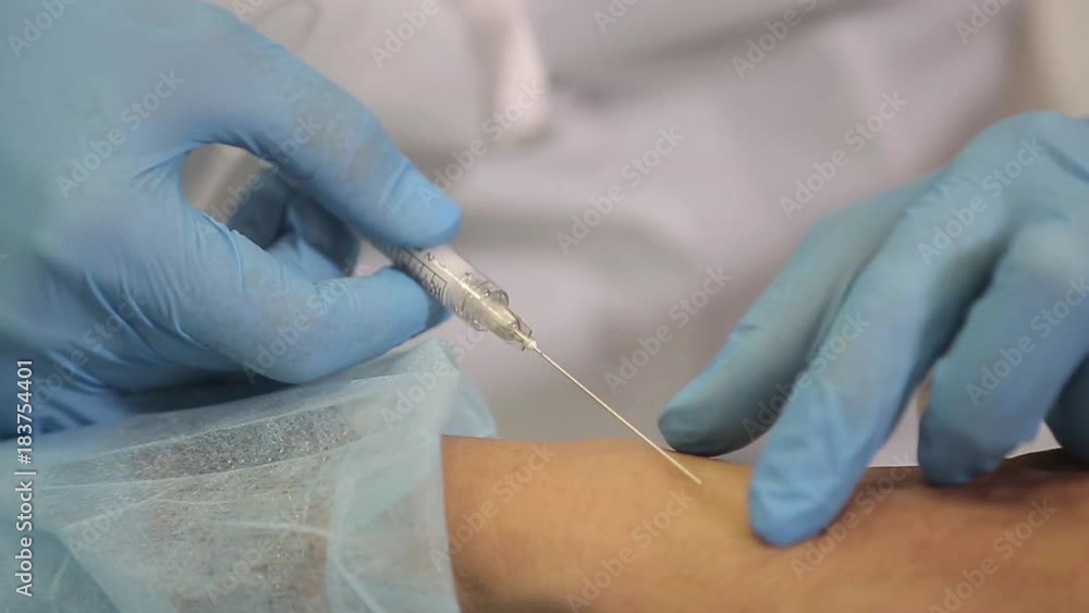 Injection Botox Needle Syringe under the Woman Hand Skin, tightening ...