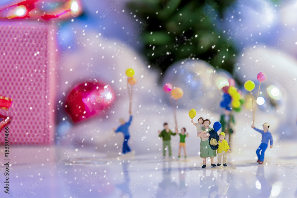 Miniature people with family holding balloon hang out in pine woods ...