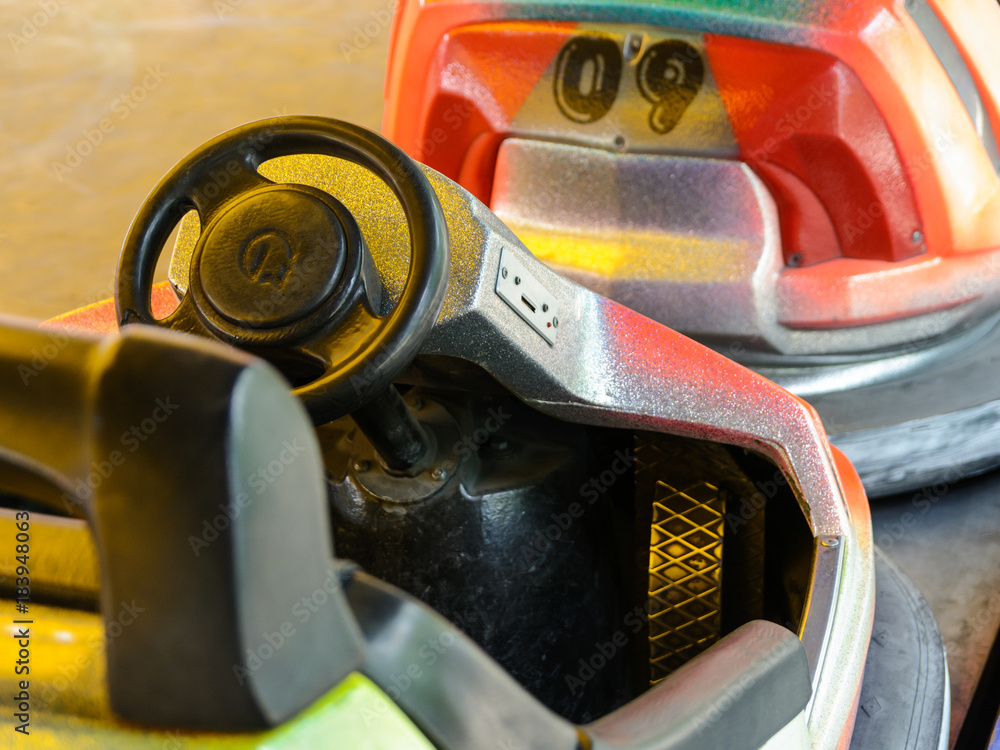 Close-up view of the cokpit of a colorful dodgem car, with steering ...