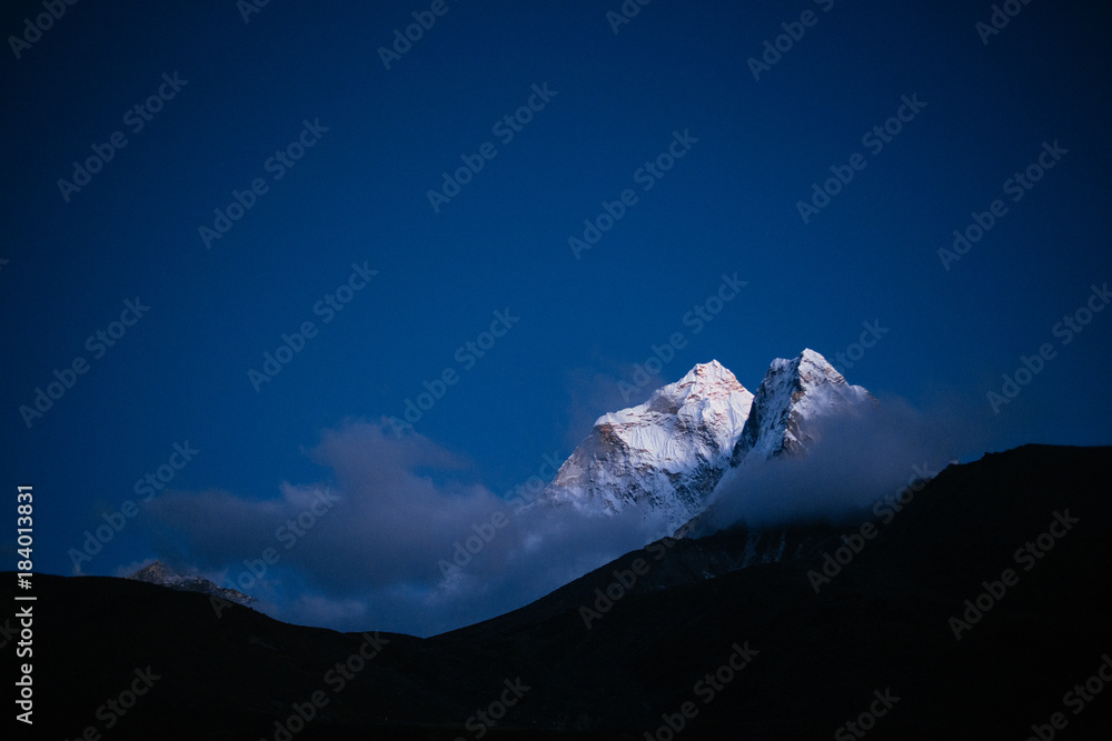 Peaks of Mount Everest rising above clouds at night Stock Photo | Adobe ...