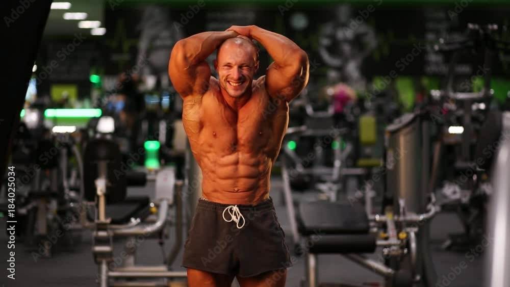 bodybuilder posing in a gym Stock Video | Adobe Stock