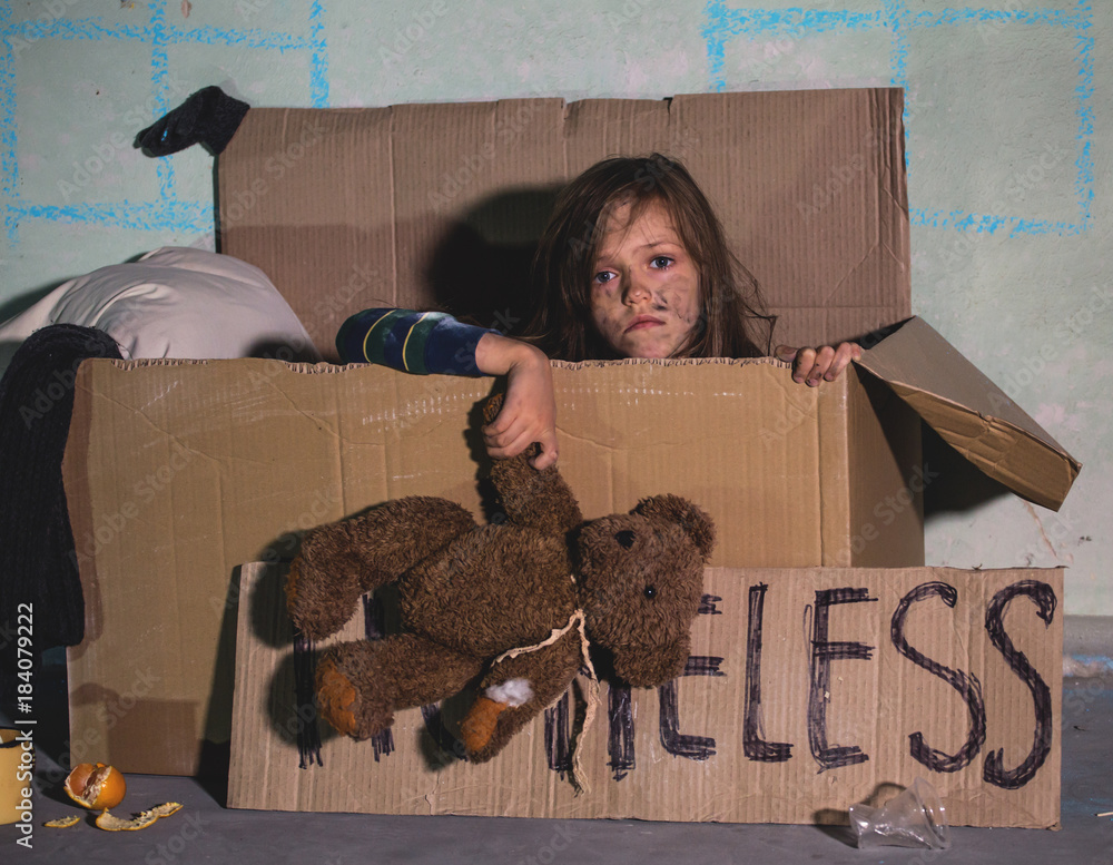 Crying homeless kid girl sitting in the cardboard box and looking at ...