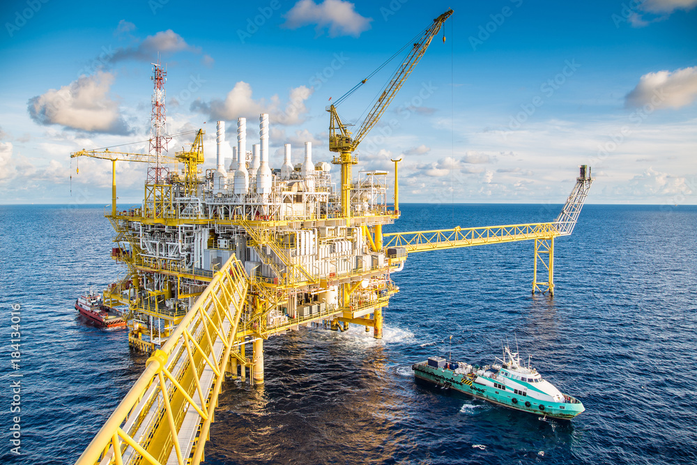 Offshore oil and gas business, boat loading cargo at offshore central ...