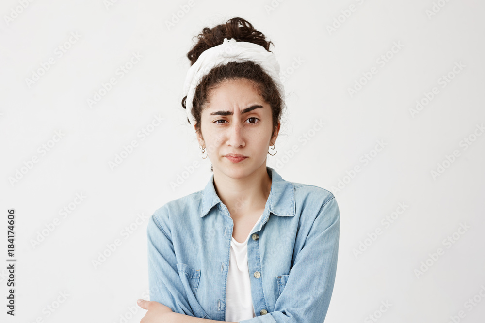 Serious unhappy girl wearing do-rag on wavy dark hair has appealing ...