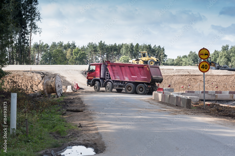 yellow paver and red dump truck. Road construction. Stock Photo | Adobe ...
