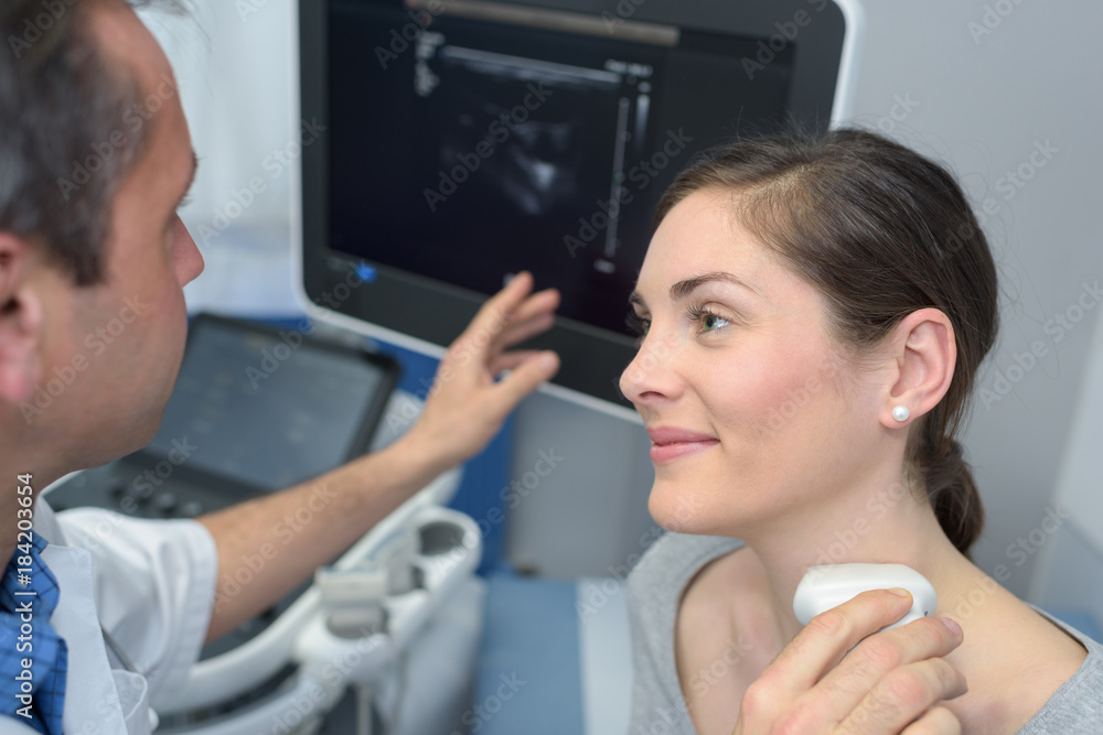 doctor performing neck ultrasound examination on female patient Stock ...