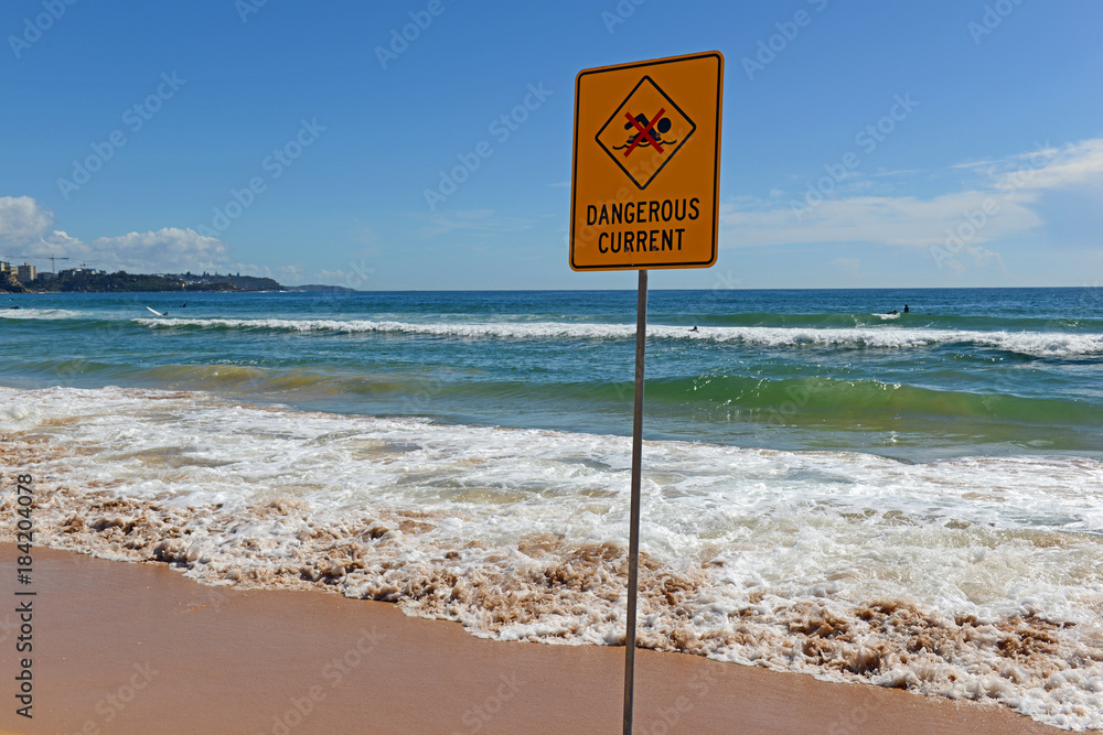 Dangerous Current sign, warning swimmers and surfers of the rough water ...