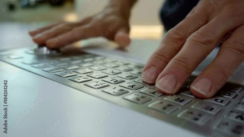 humans hands are typing and using roller ball mouse, close-up shot of ...