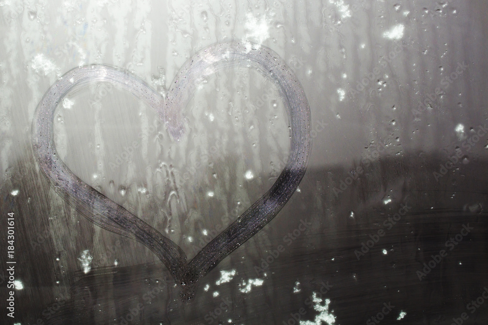 Sticky snow on a hand-drawn heart on the sweaty glass. Stock Photo ...