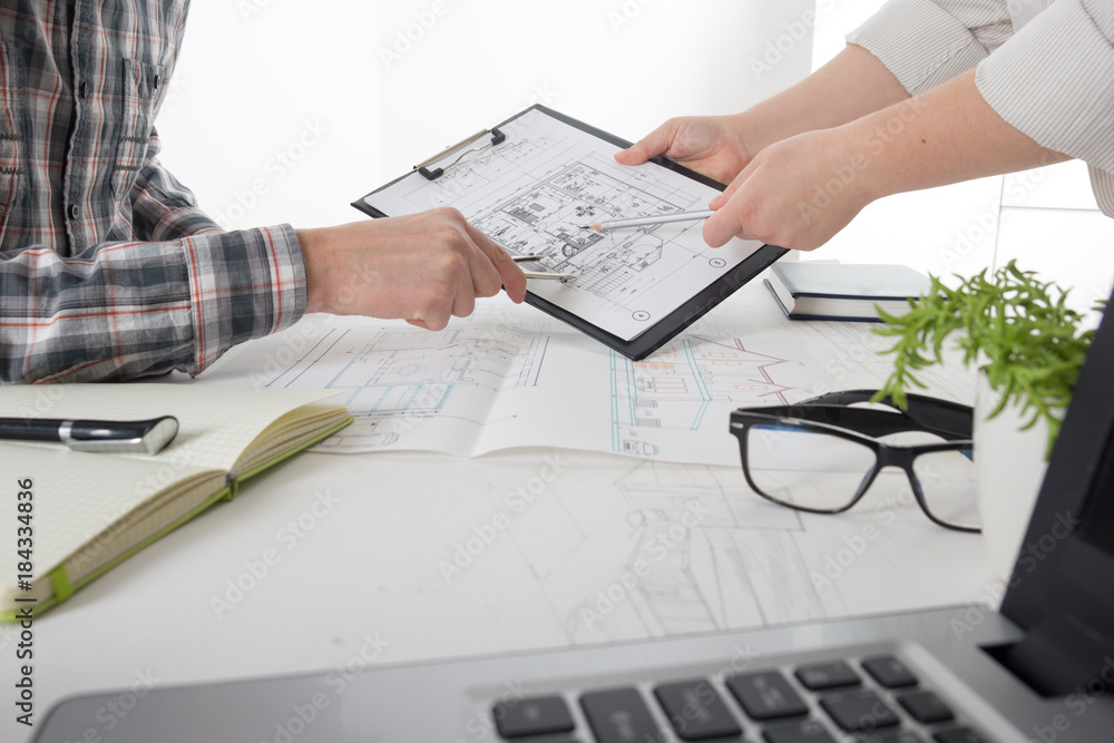 Architects working on blueprint, real estate project. Architect ...