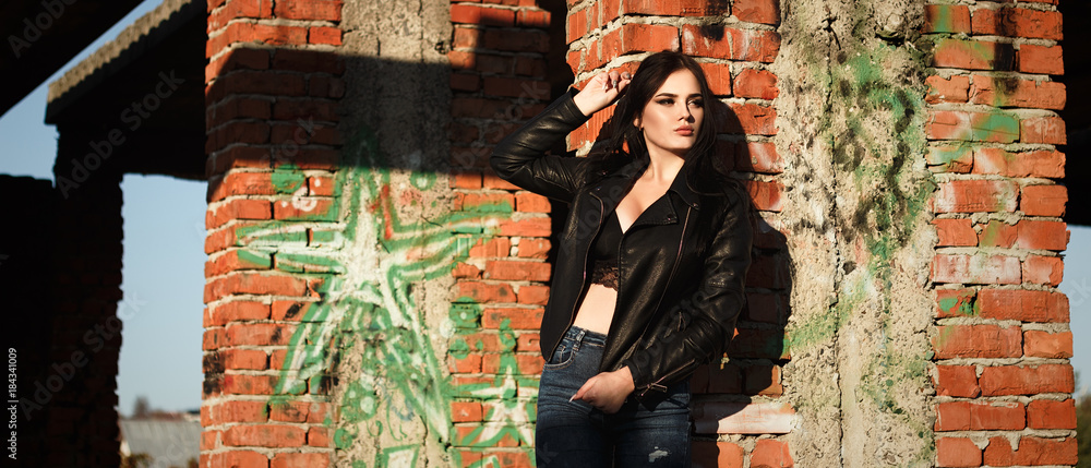 urban portrait Pretty girl in bra leather jacket with beautiful makeup ...