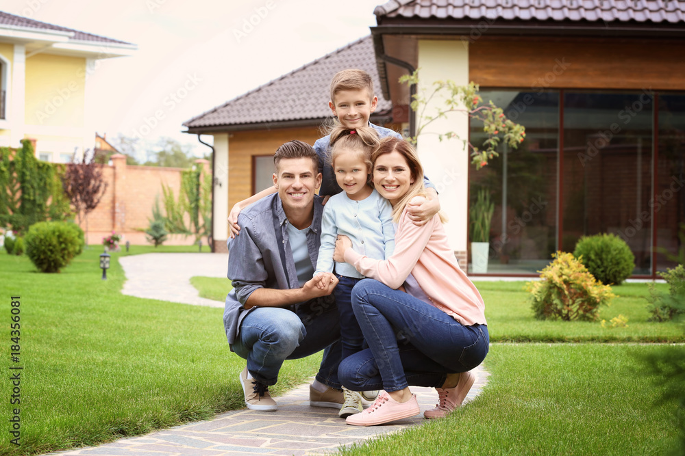 Happy family in courtyard near their house Stock Photo | Adobe Stock