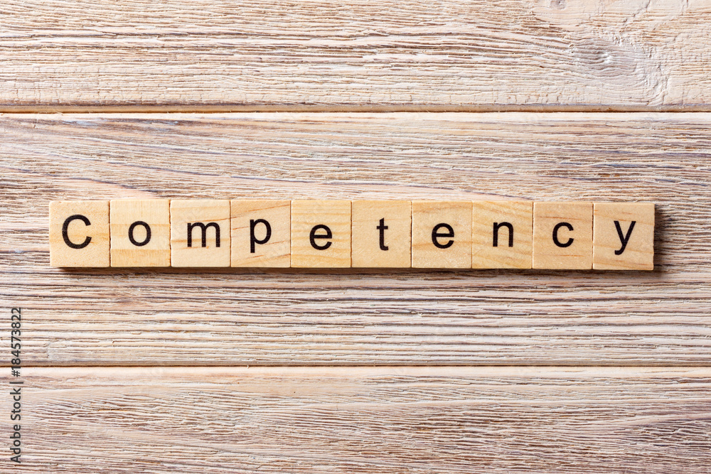 Competency word written on wood block. Competency text on table ...