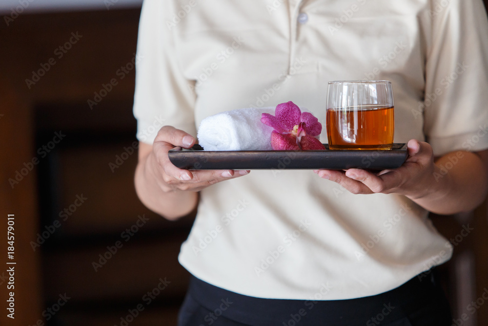 The woman serving welcome drink there were cold water with cool cloth ...