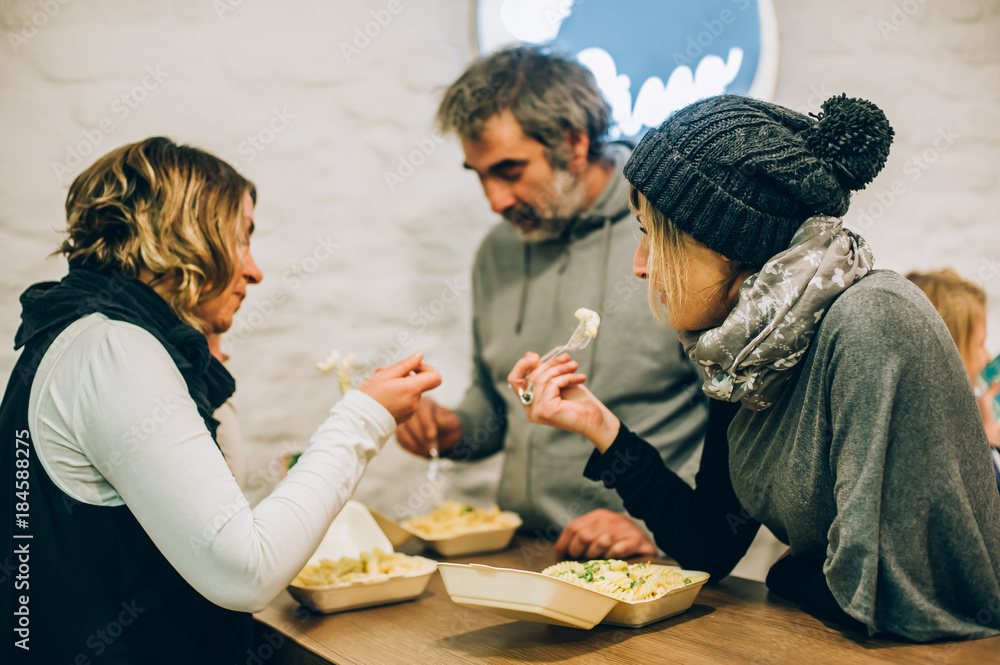 Group of people eat spaghetti pasta in fast food restaurant Stock Photo ...