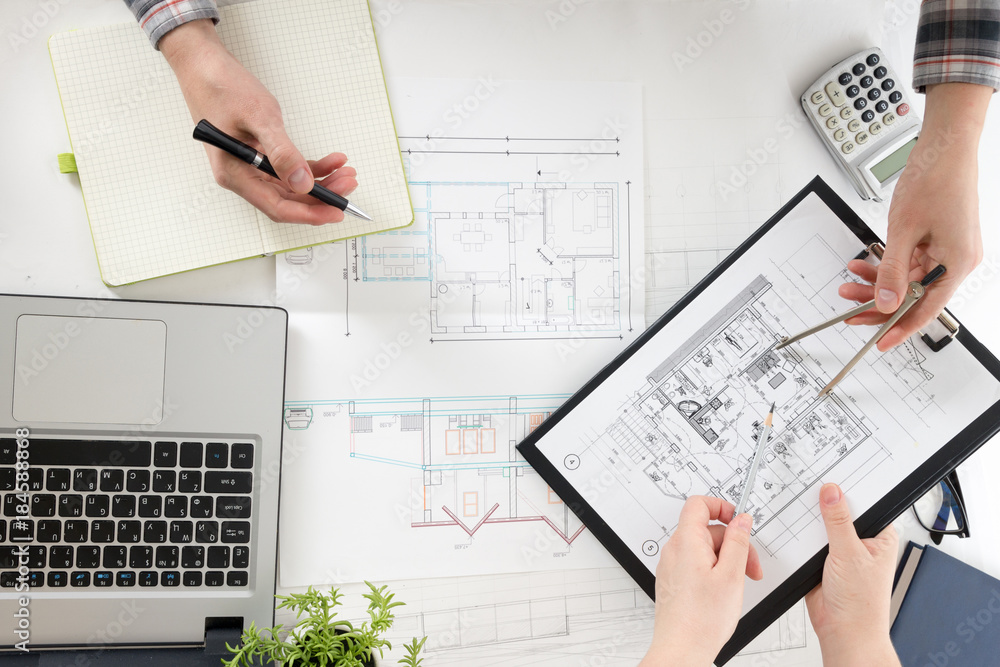 Architects working on blueprint, real estate project. Architect ...