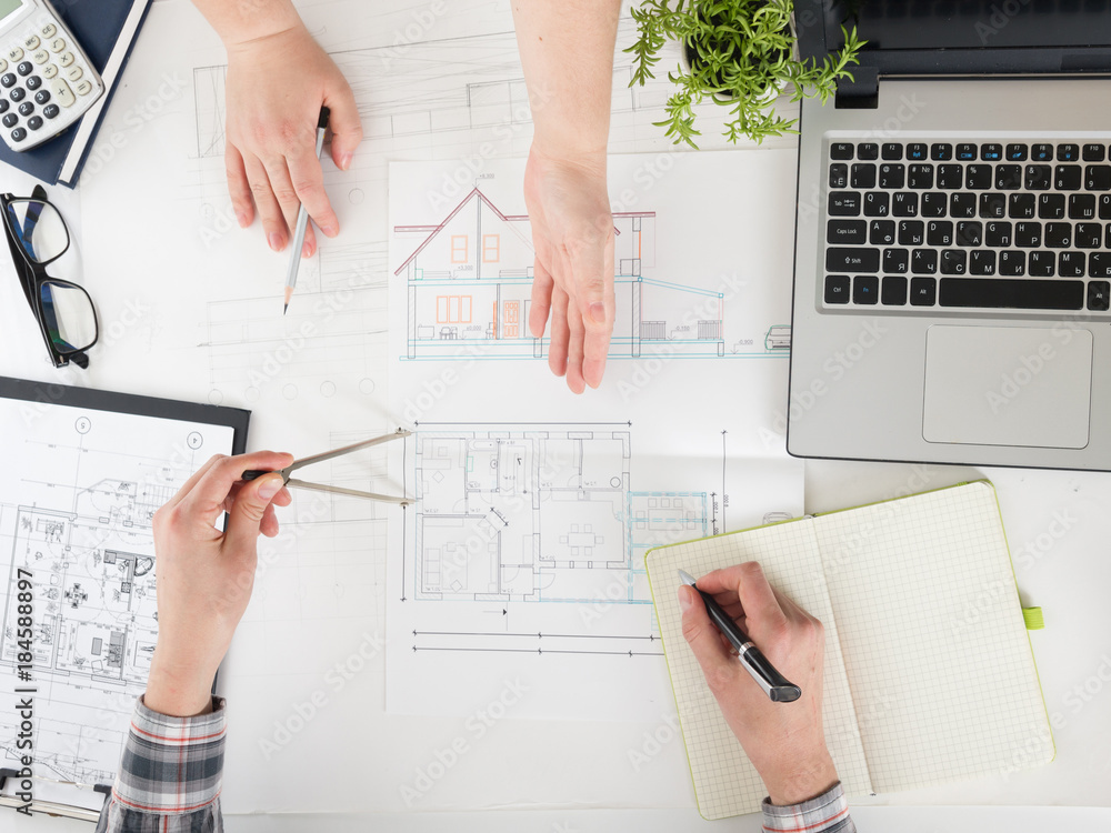 Architects working on blueprint, real estate project. Architect ...