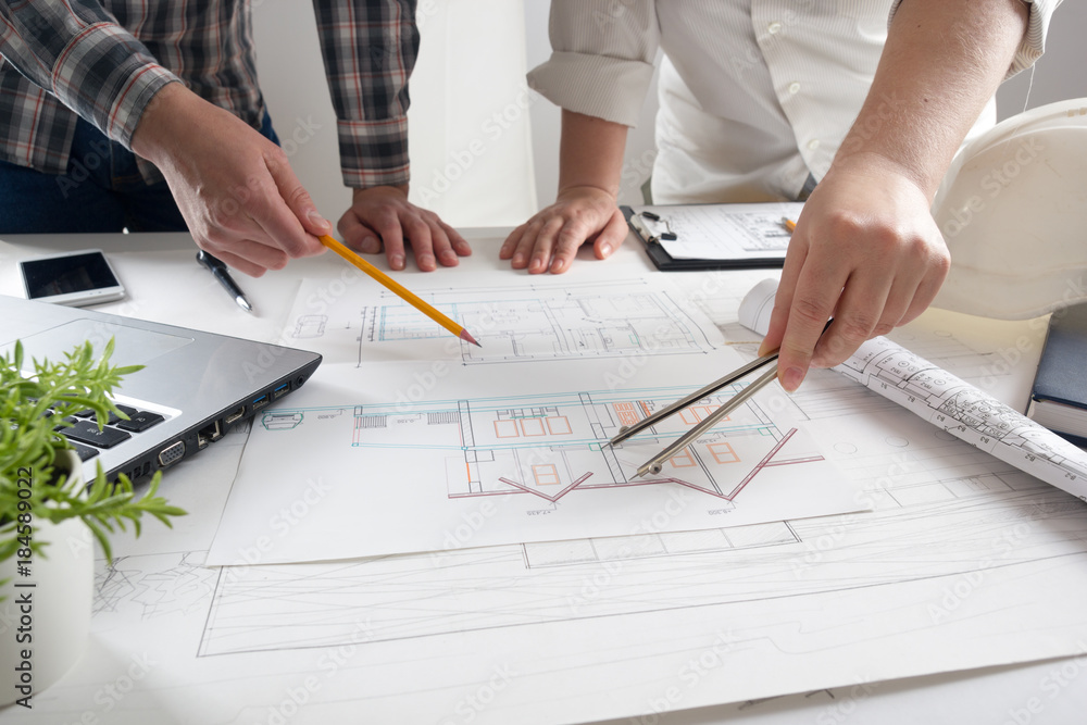 Architects working on blueprint, real estate project. Architect ...