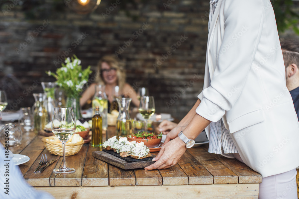 Woman Dinner Party Host Serving Food to Her Friends Stock-Foto | Adobe ...