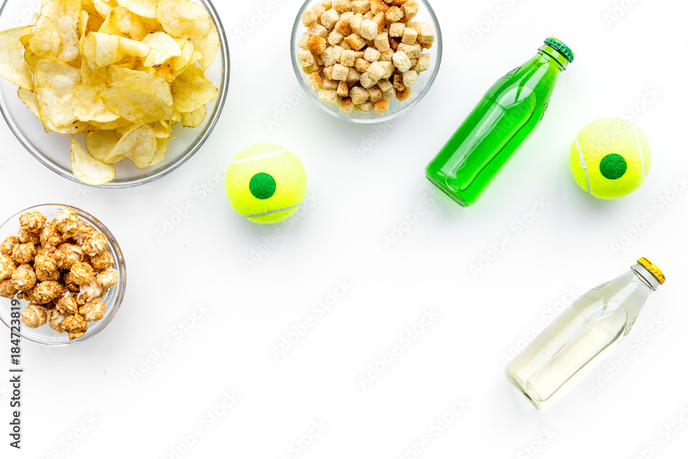 Snacks for watching TV. Crisps, popcorn, rusks near drinks on white ...