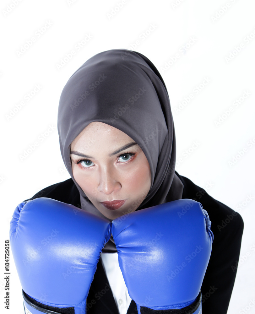 Executive Muslimah wearing boxing gloves with fighting pose isolated ...