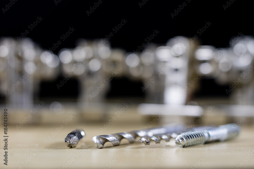 Carpentry tools and accessories on a workshop table. Hinges and screws ...