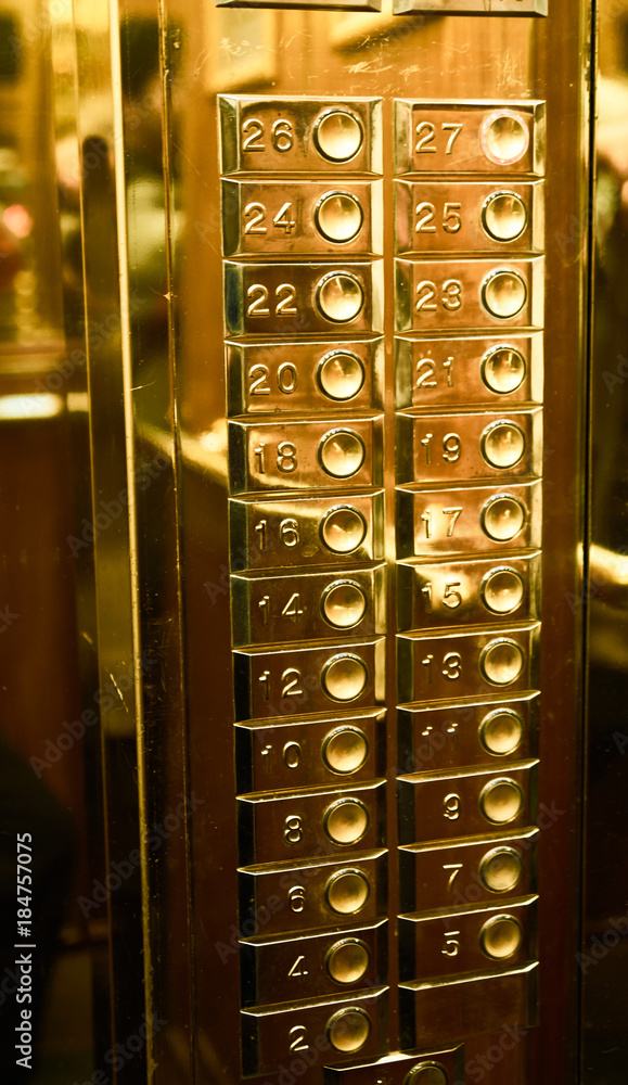 Gold buttons in the golden elevator. Stock Photo | Adobe Stock