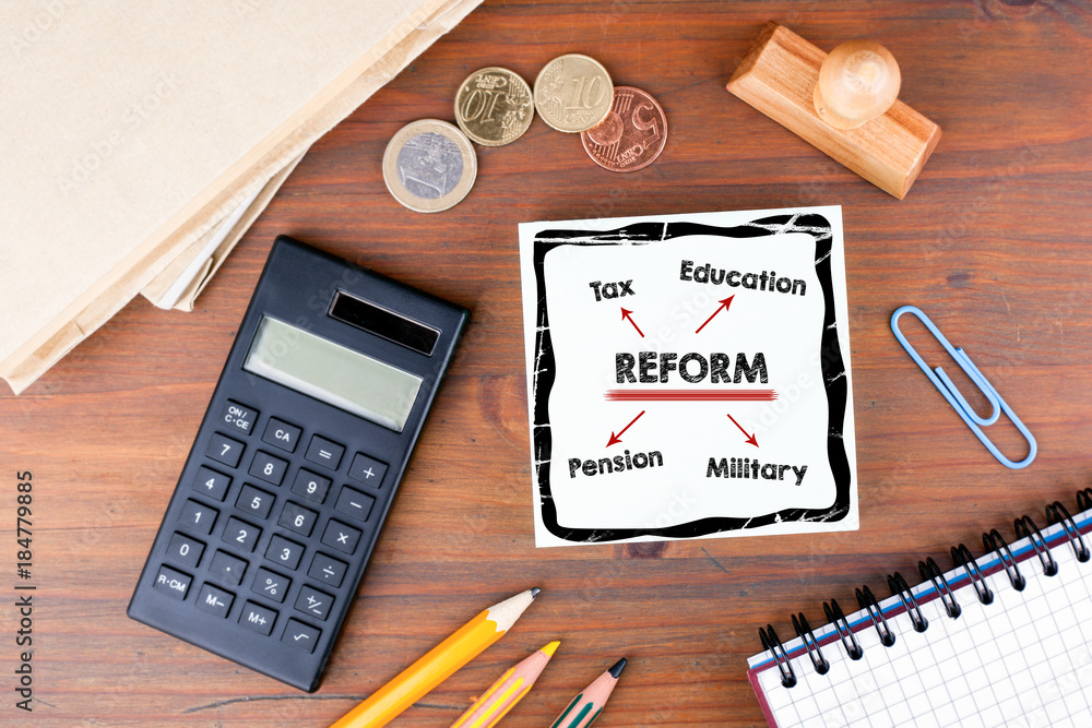 reform concept. Office desk with stationery, chart and communication ...