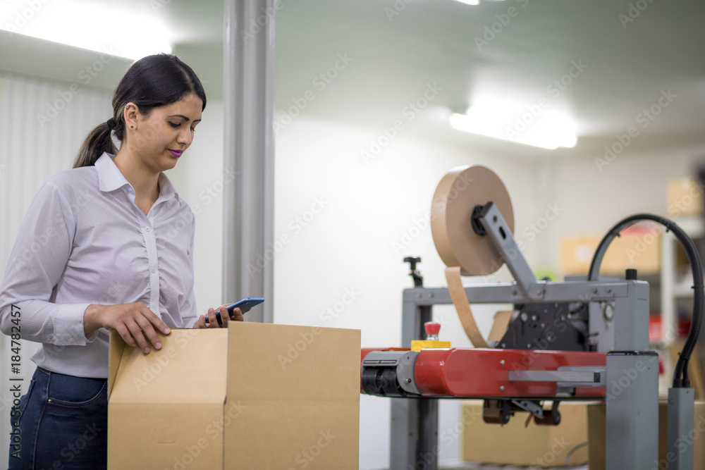 latina worker portrait in packaging plant. Stock Photo | Adobe Stock