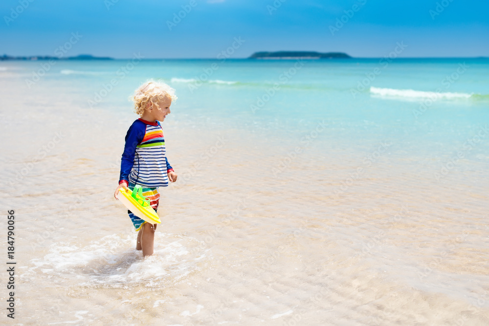 Child on tropical beach. Sea vacation with kids. Stock Photo | Adobe Stock
