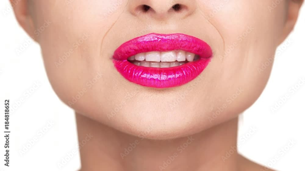 Face details of female lips covered by pink shining lipstick doing ...