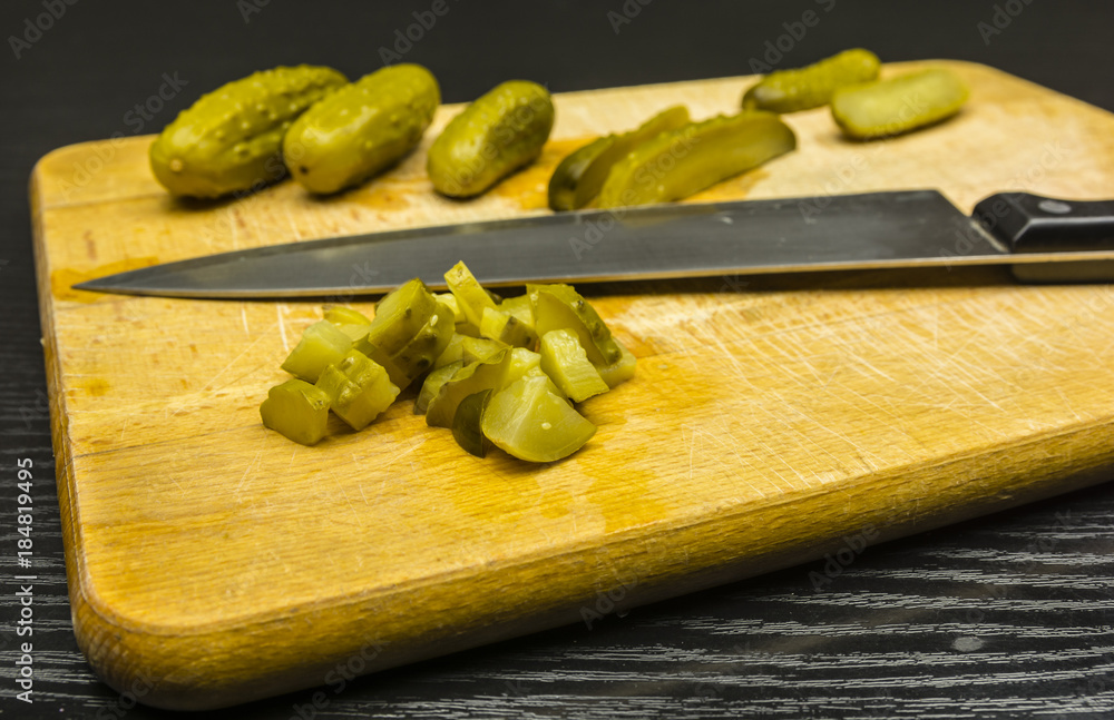 Chopped pickled cucumbers on a chopping board. Stock Photo | Adobe Stock