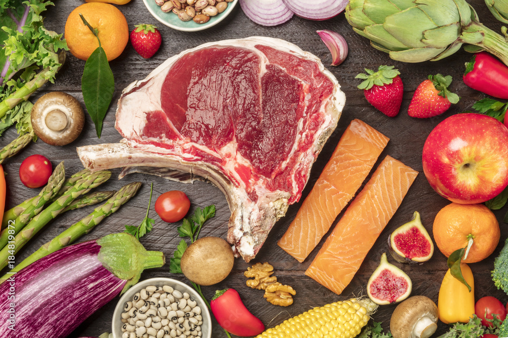 Overhead photo of various foods. Vegetables, legumes, fruits, fish, and ...