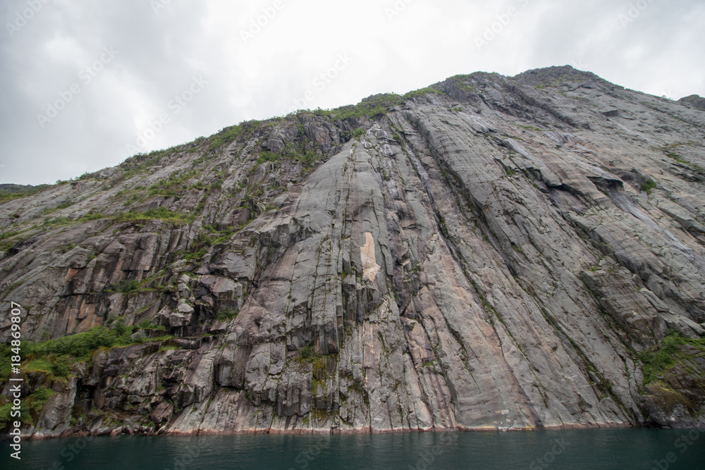 The huge mountain wall in Trollfjorden in Nordland county, Norway. The ...
