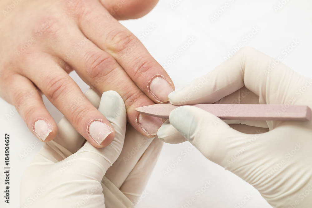 The process of the master's work in the manicure salon of female nails ...