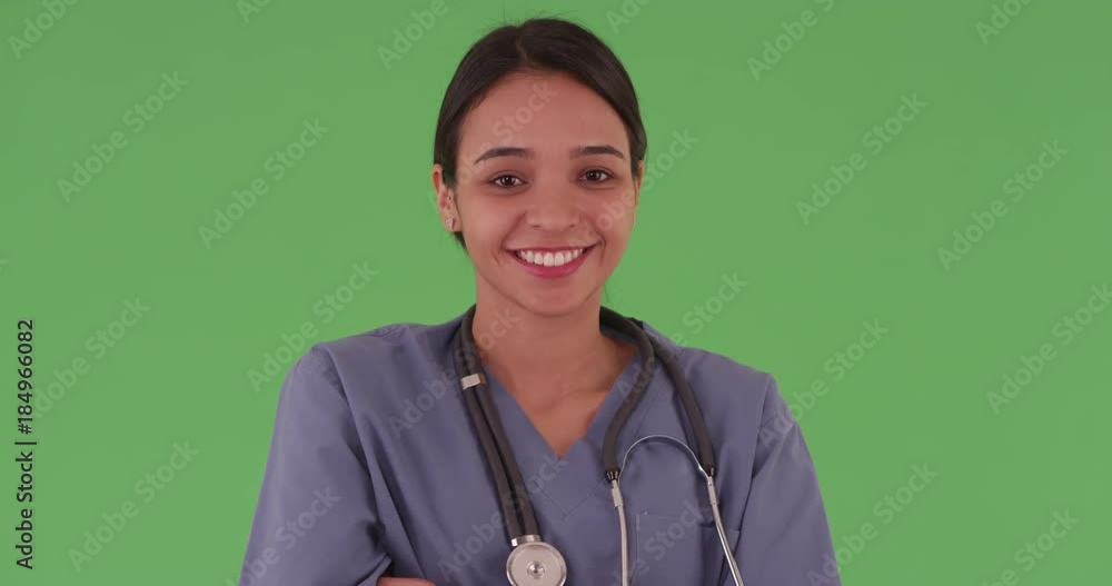 Close up of smiling Hispanic woman doctor or nurse on green screen for ...